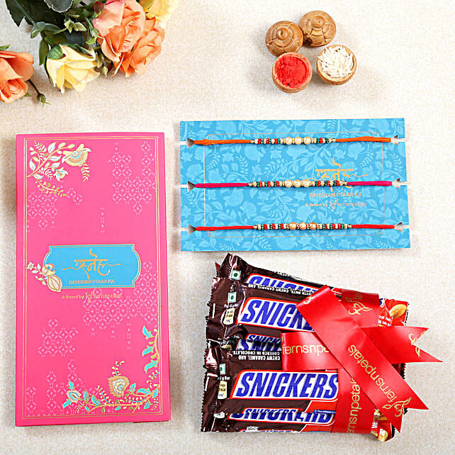 Buy/Send Set of 3 Beautiful Pearl Rakhi and Snickers Chocolates Online- FNP